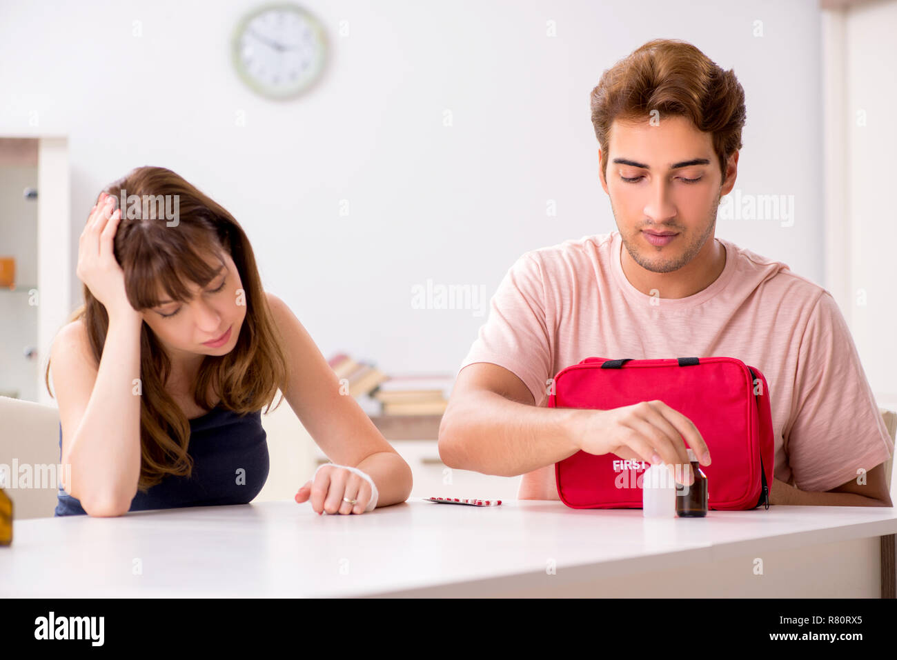 Young family getting treatment with first aid kit Stock Photo - Alamy