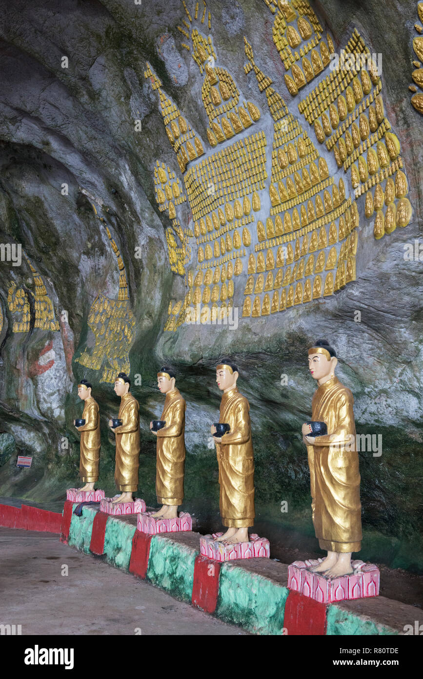 Vertical picture of monks statue and beautiful ornated walls inside ...