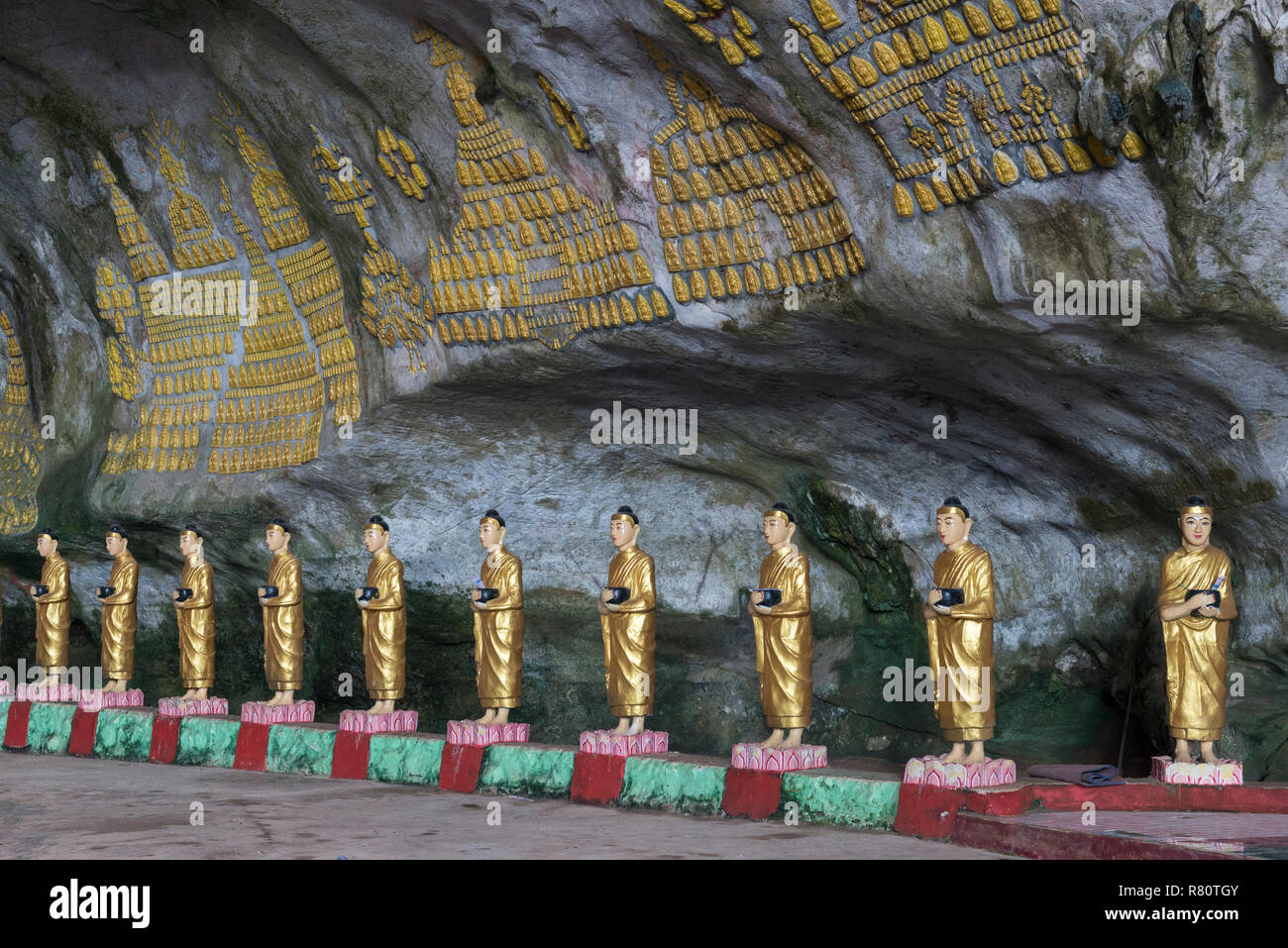 Horizontal picture of aligned monks statue and ornated walls inside ...
