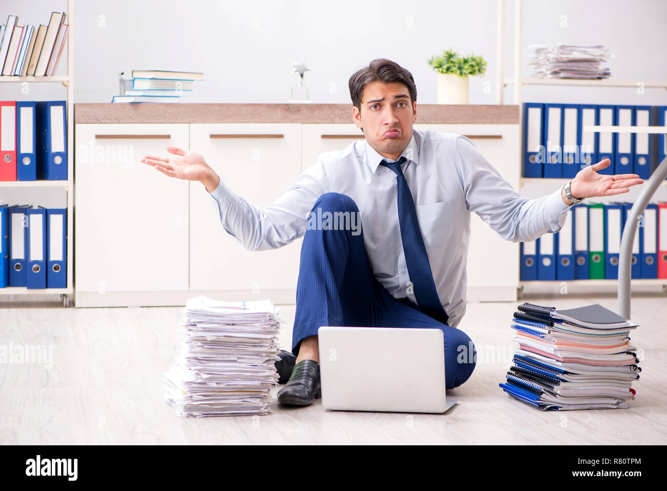 Extremely busy employee working in the office Stock Photo - Alamy