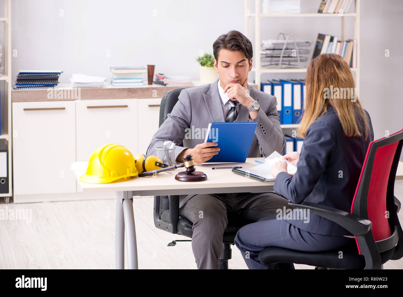 Lawyer talking to client in office Stock Photo - Alamy