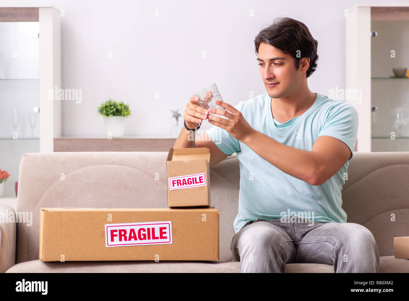 Man opening fragile parcel ordered from internet Stock Photo - Alamy
