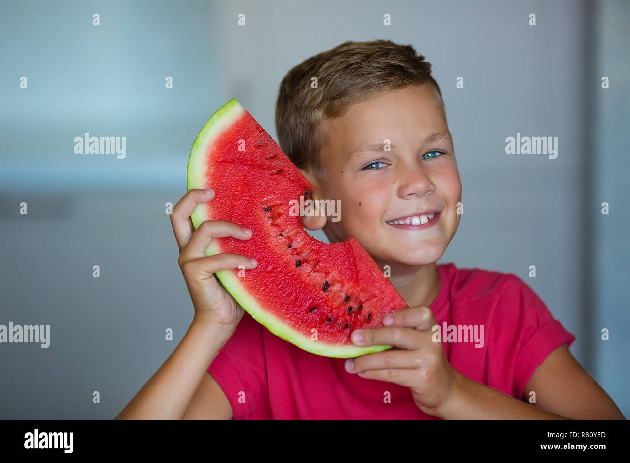 Cute kid enjoy summer juicy berry fruit watermelon Handsome blue eyes ...