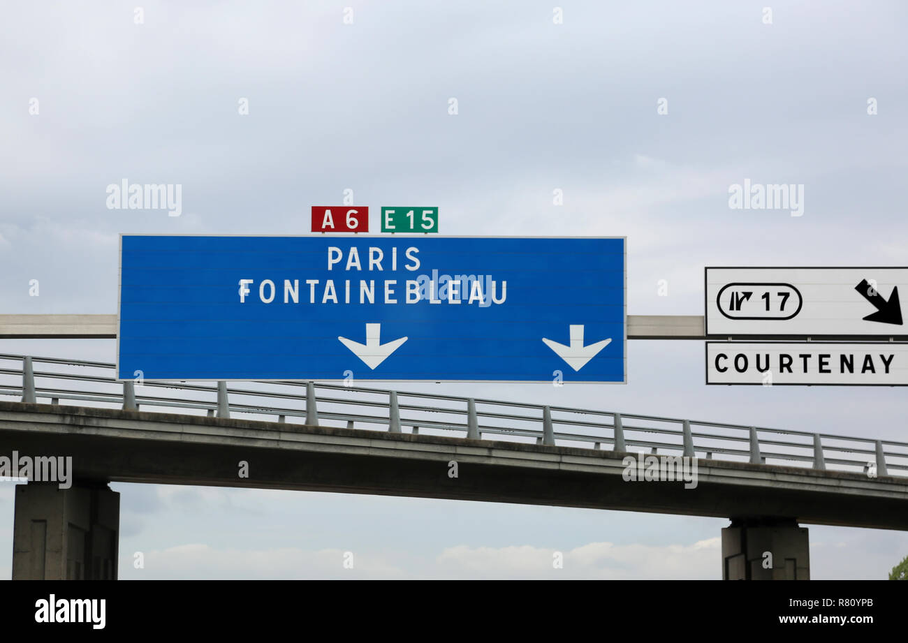 blue motorway sign with directions to Paris and Fontainebleau Stock ...