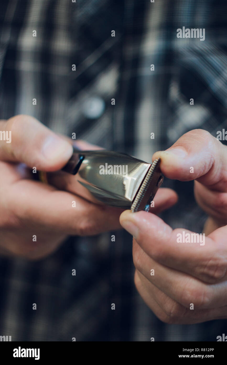 Electric hair trimmer. Barber's hands with holding razor Stock Photo ...