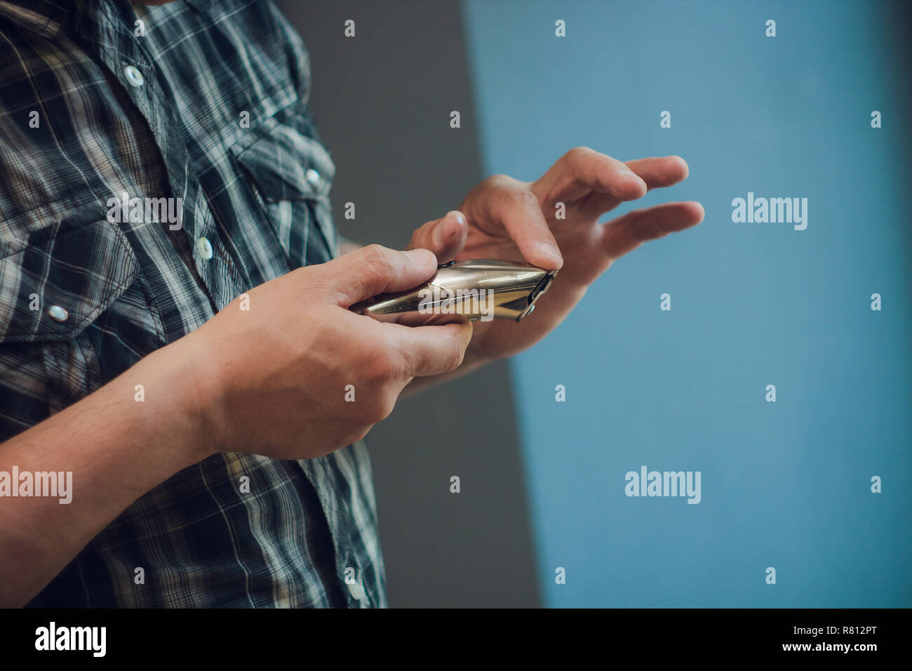 Electric hair trimmer. Barber's hands with holding razor Stock Photo ...
