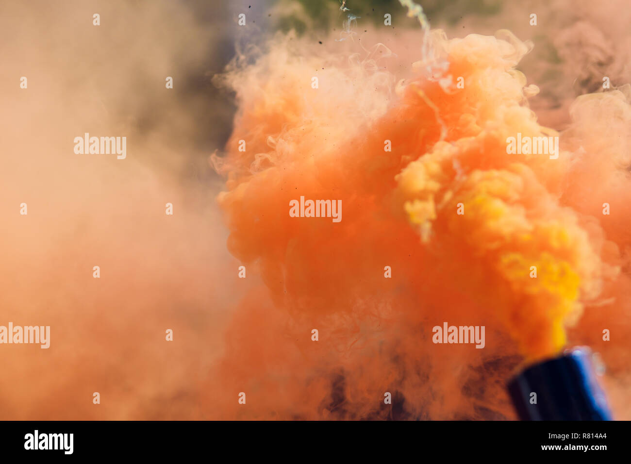 colorful orenge smoke bombs in action Stock Photo - Alamy