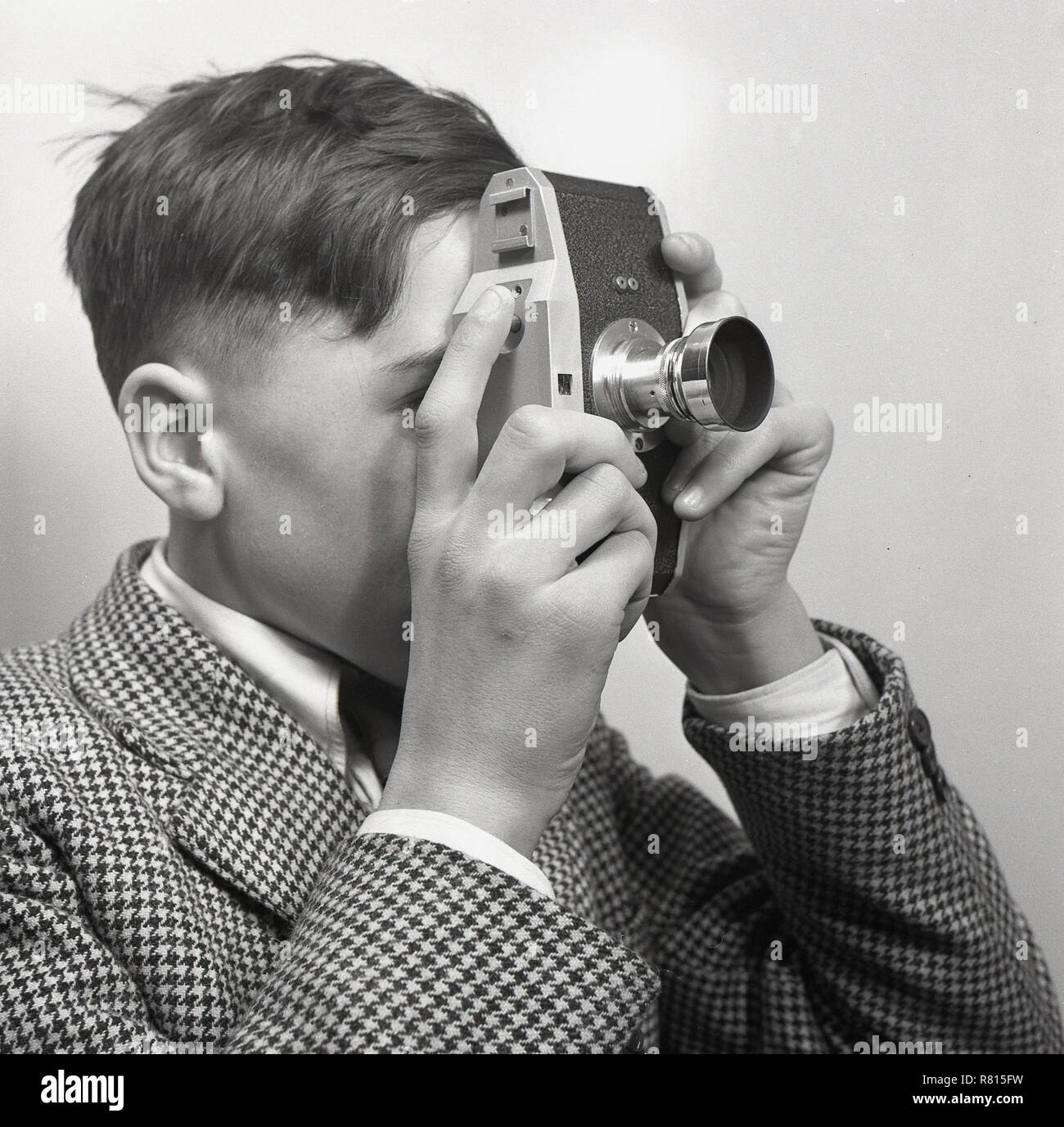 1950s, film photography, a teenage boy wearing a cheque jacket, using a ...