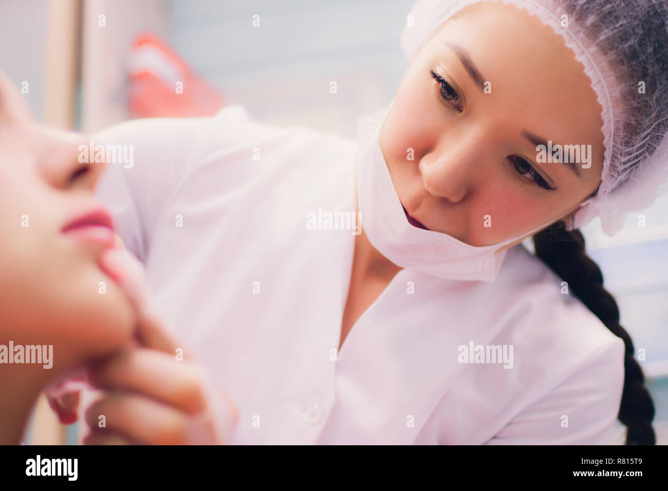 Young Woman Gets an Injection in her Lips in Beauty salon. Beauty ...