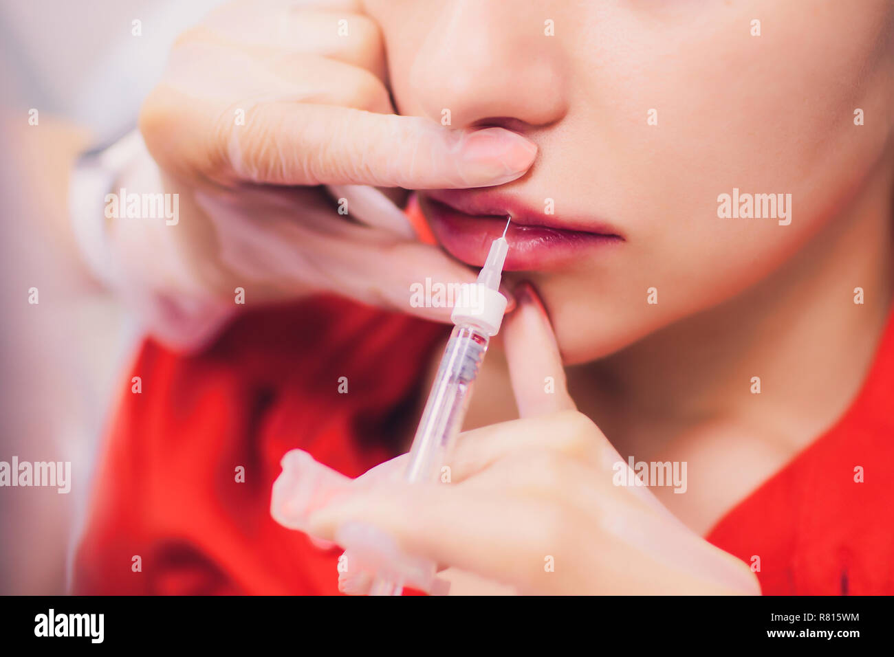 Young Woman Gets an Injection in her Lips in Beauty salon. Beauty ...