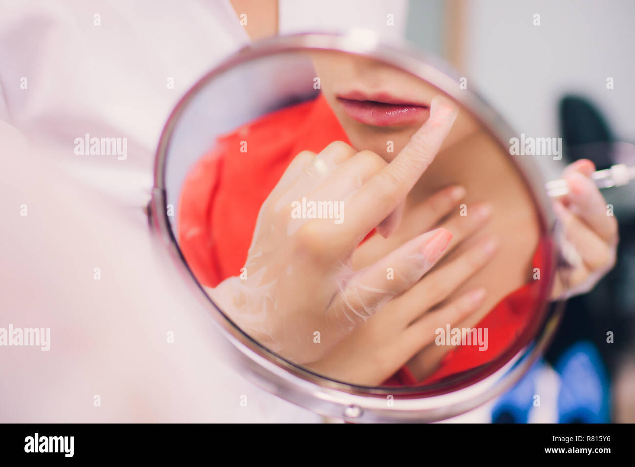Young Woman Gets an Injection in her Lips in Beauty salon. Beauty ...