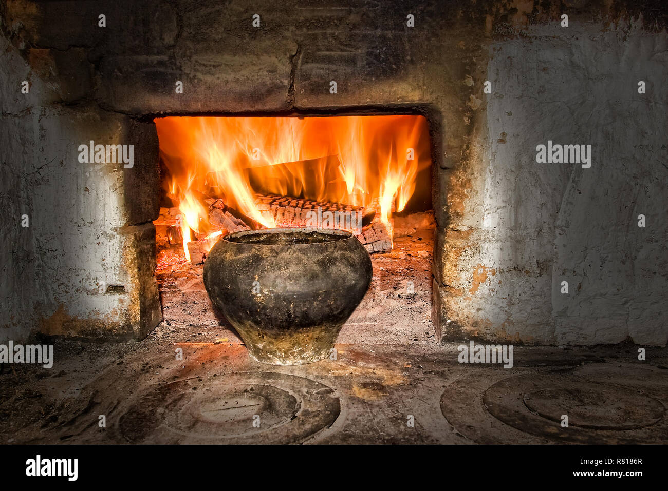 Retro russian stove with iron pot and burning firewood close up Stock ...