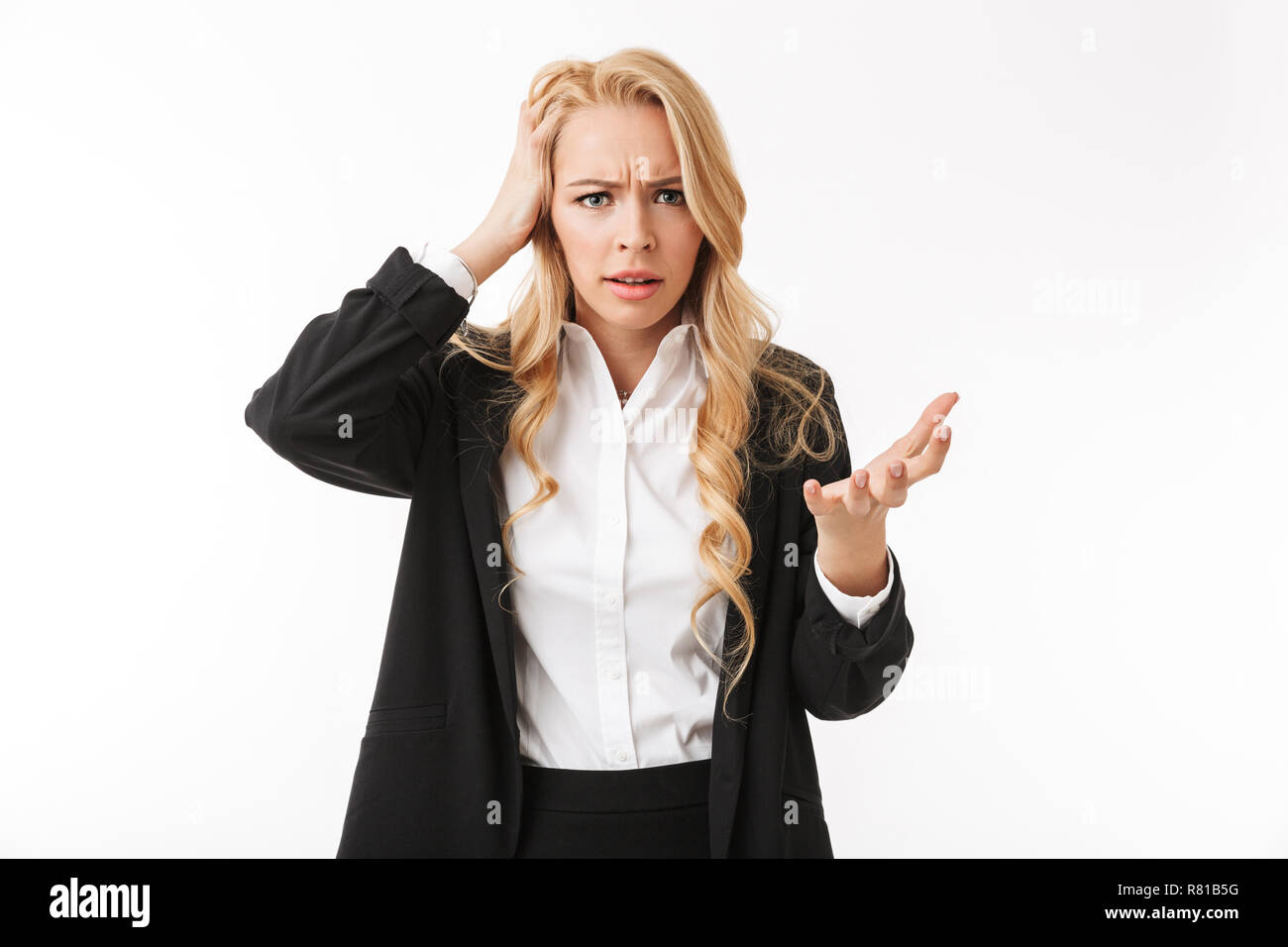 Image of a confused angry displeased business woman posing isolated ...