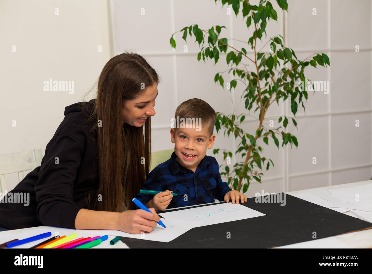 little boy draws markers from lesson mother Stock Photo - Alamy