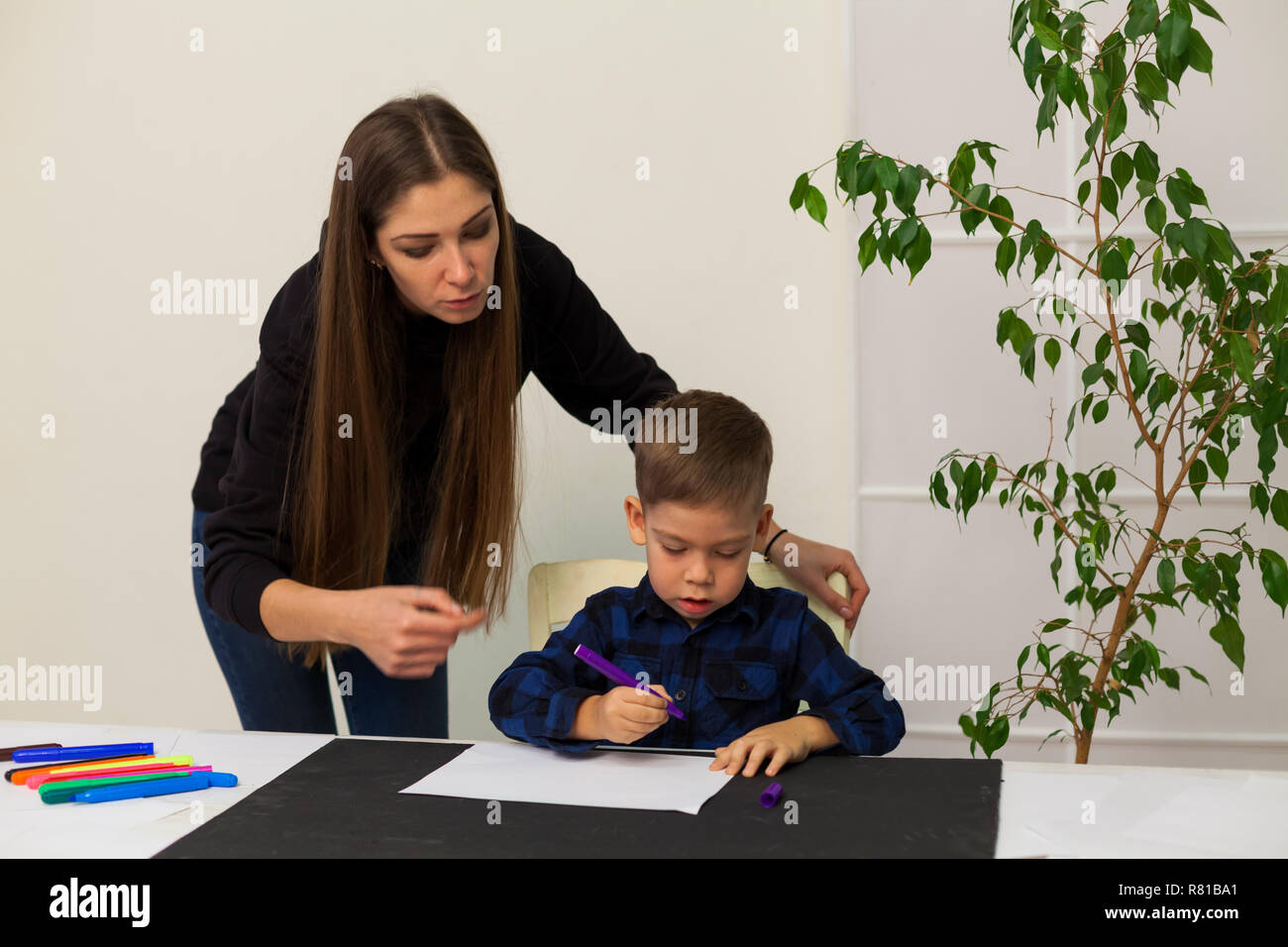 little boy draws markers from lesson mother Stock Photo - Alamy