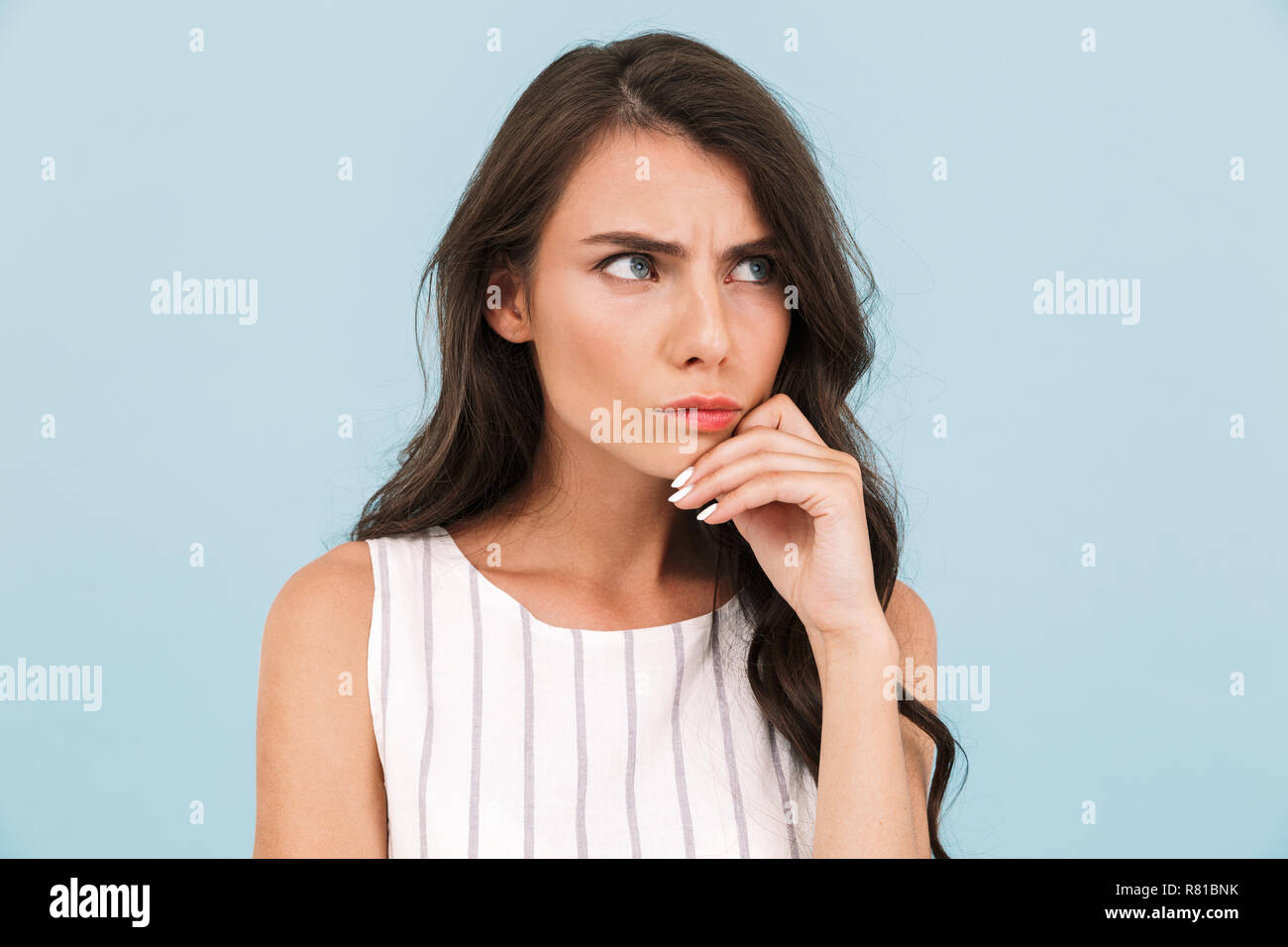 Image of emotional displeased young woman posing isolated over blue ...