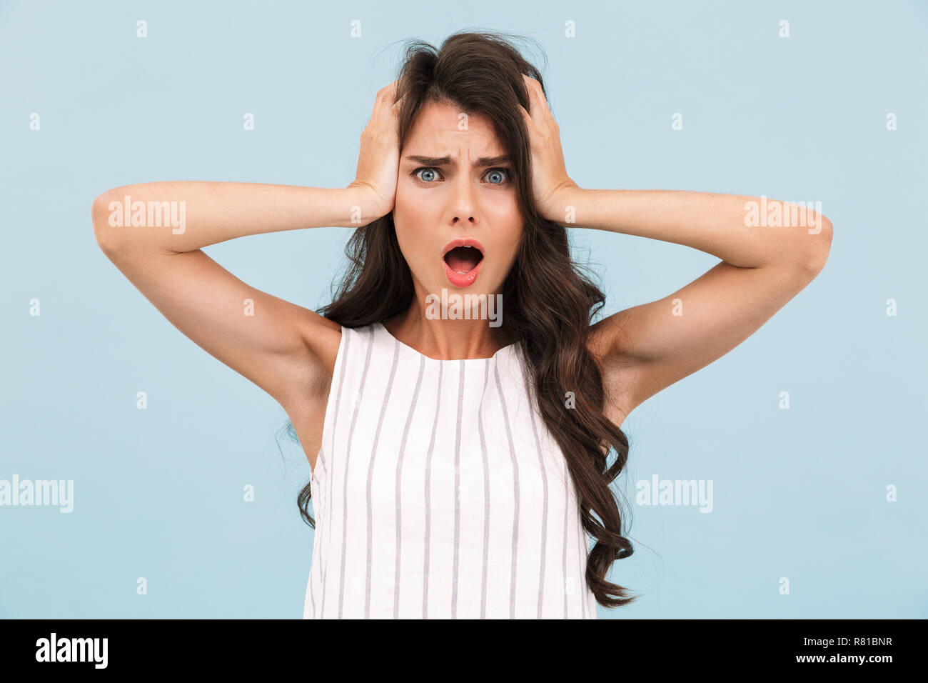 Image of emotional displeased young woman posing isolated over blue ...