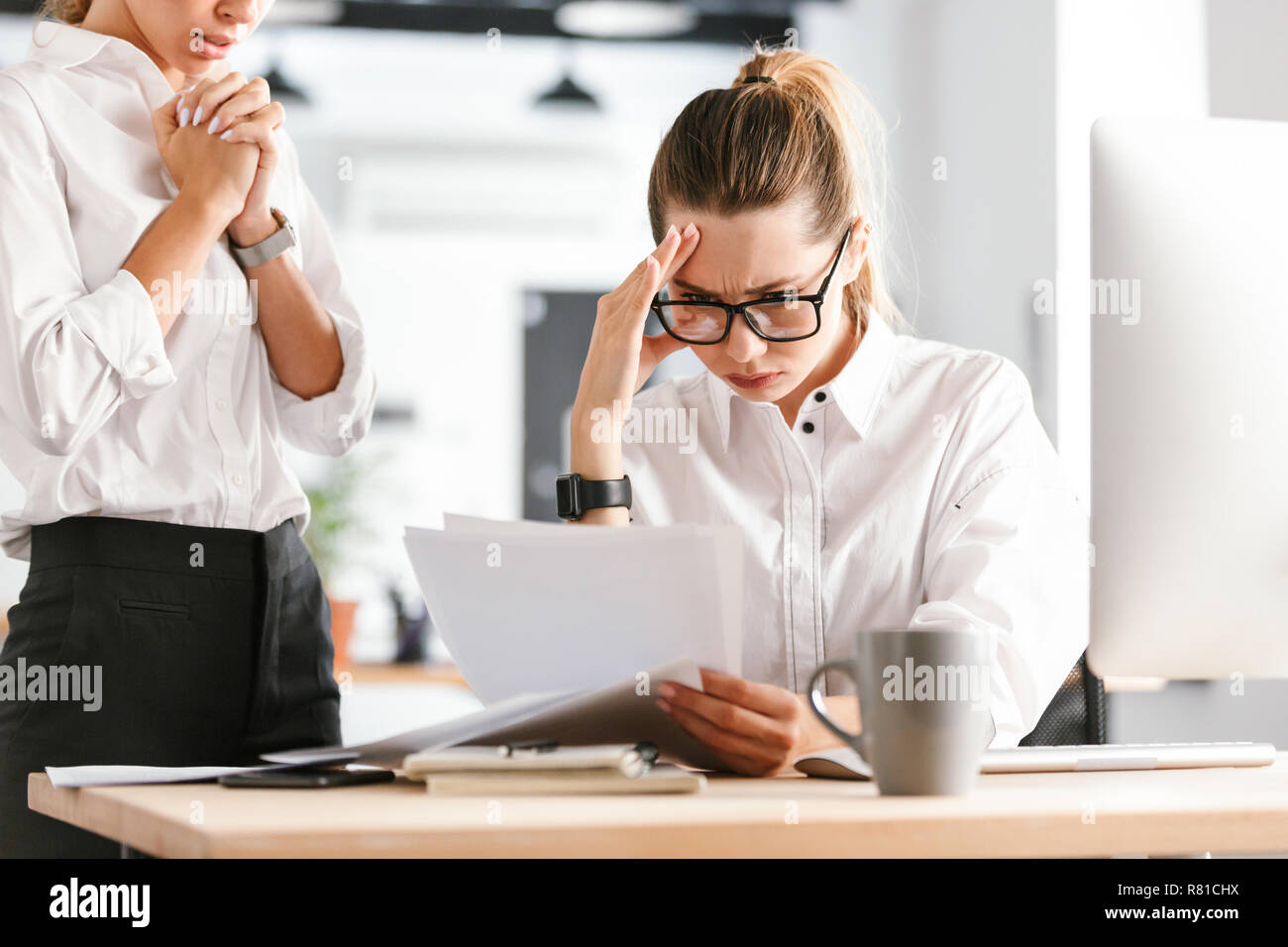 Image of a concentrated nervous colleagues business women in office ...