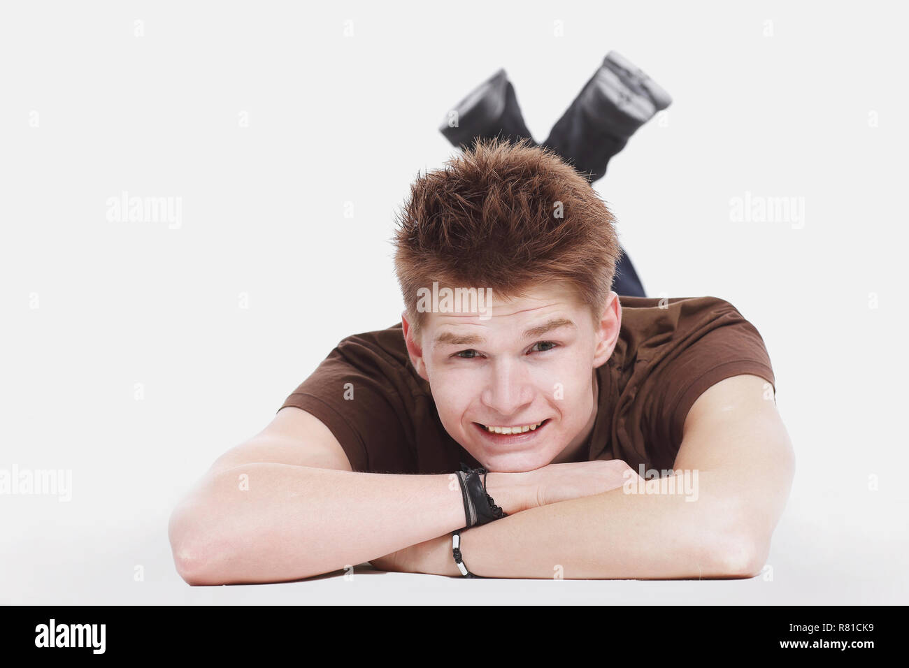 closeup. modern guy lying on the floor and looking at camera Stock ...