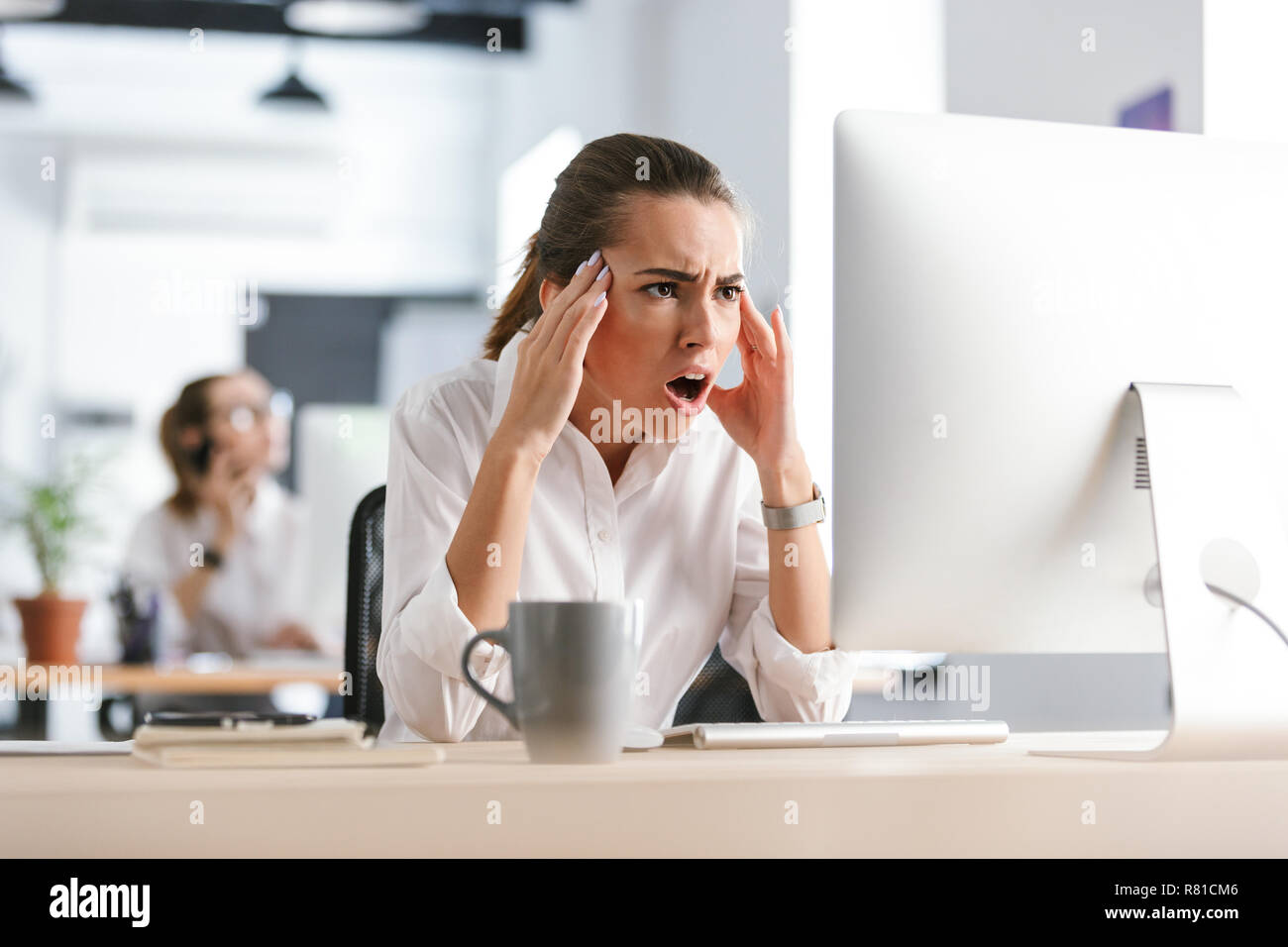 Image of a tired confused bored young business woman work in the office ...