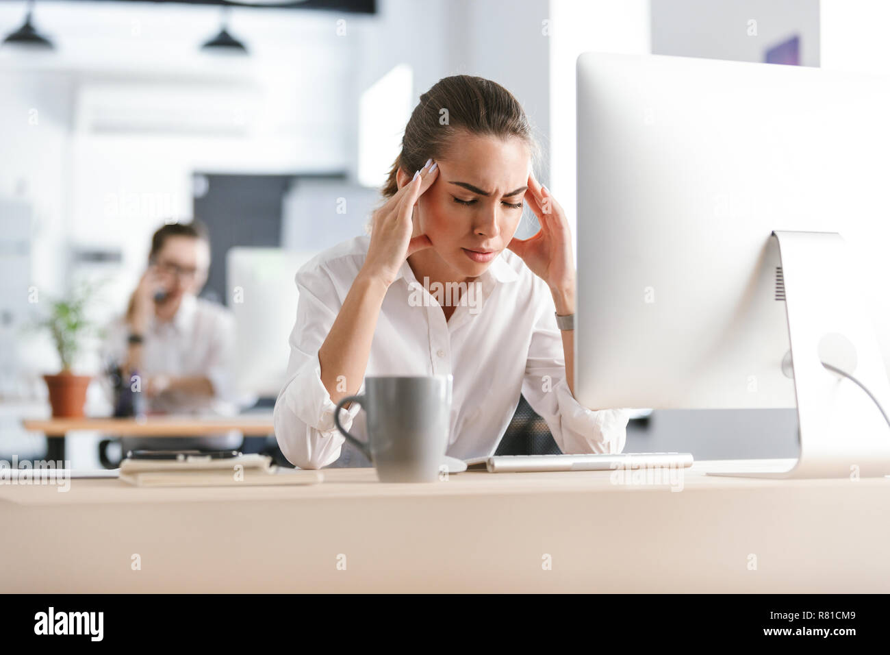 Image of a tired confused bored young business woman with headache work ...