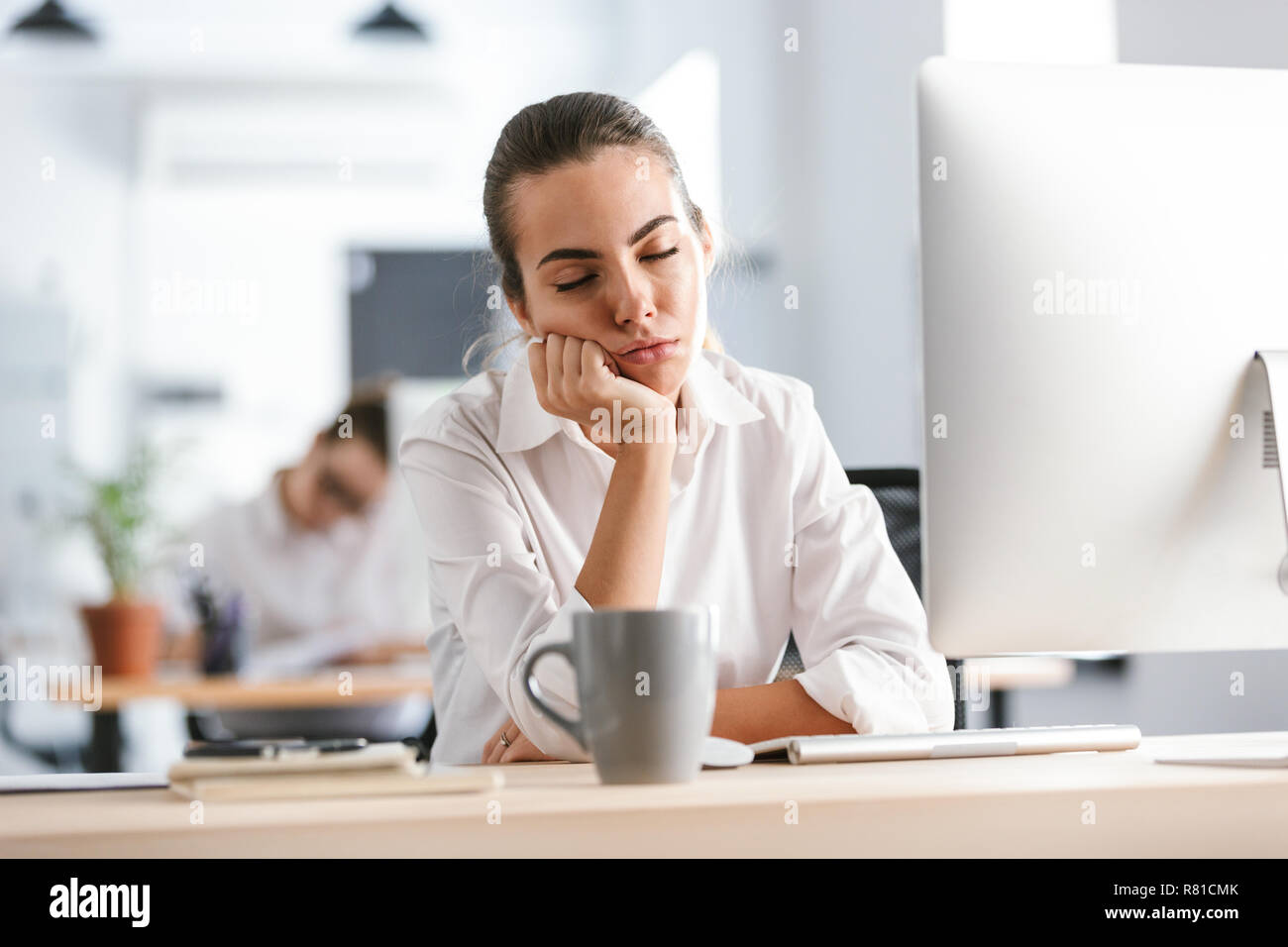 Image of a tired confused bored young business woman work in the office ...