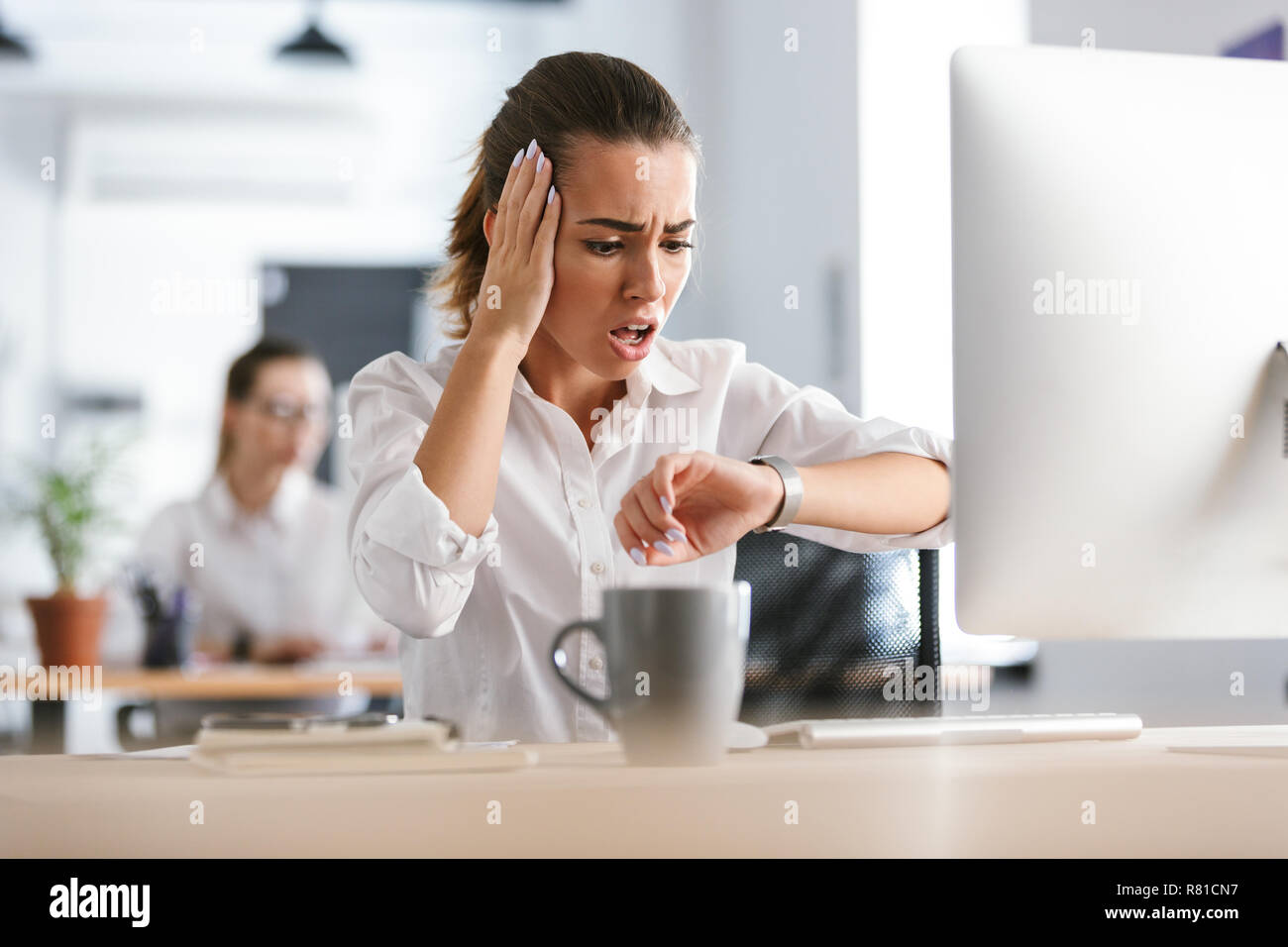 Image of a confused young business woman work in the office with ...