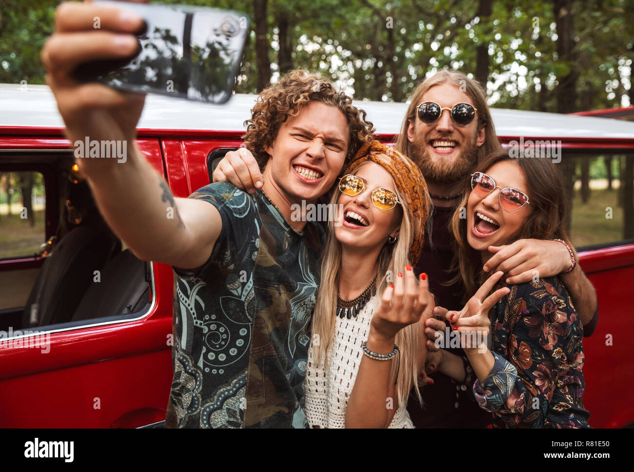 Image of four hipsters men and women smiling and taking selfie on ...