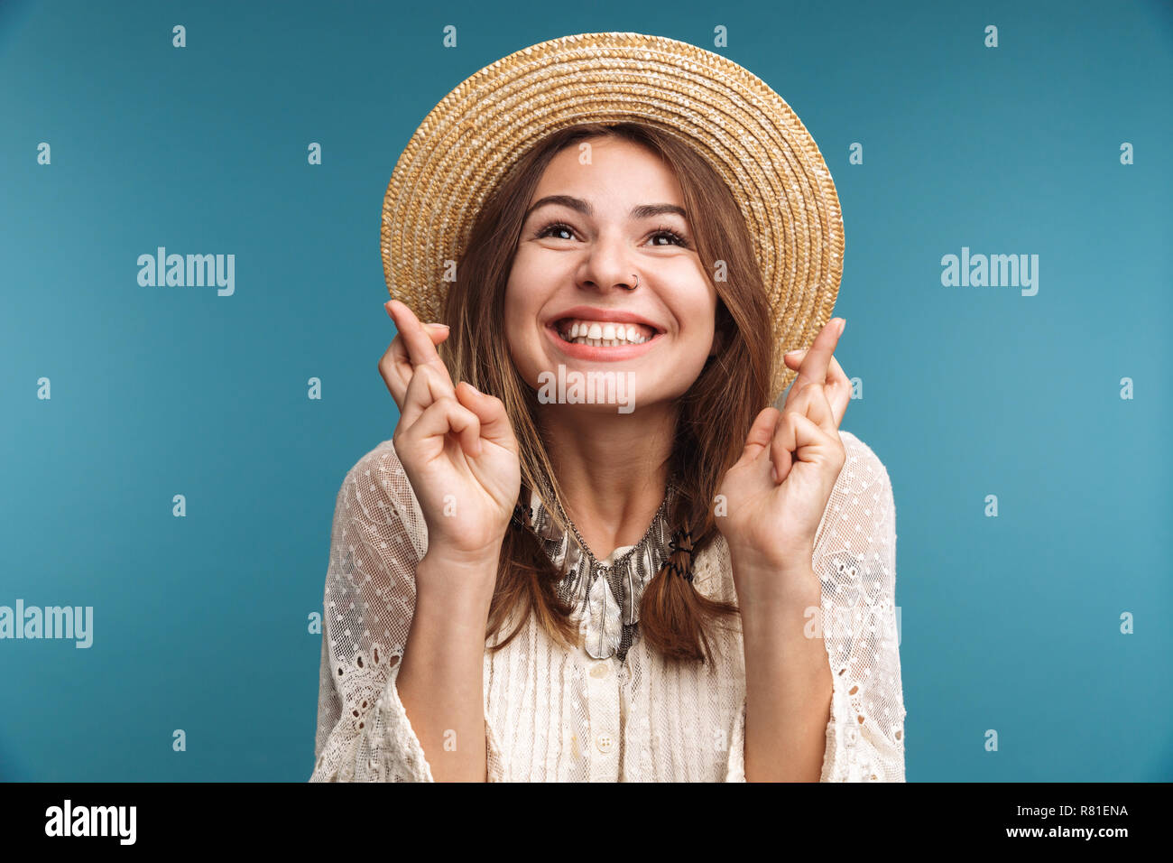 Image of a happy pretty woman posing isolated over blue wall background ...