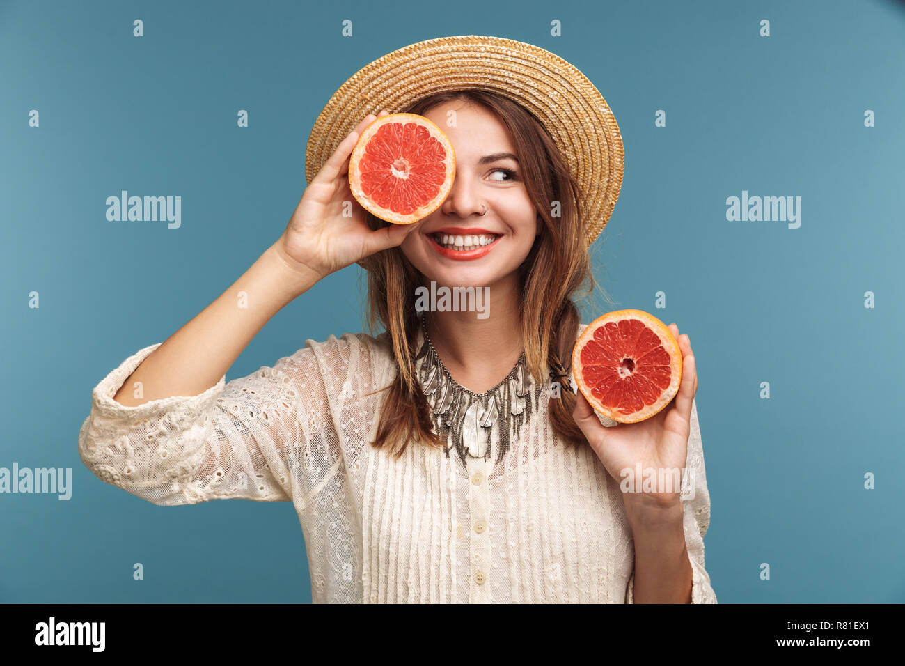 Image of a happy pretty woman posing isolated over blue wall background ...