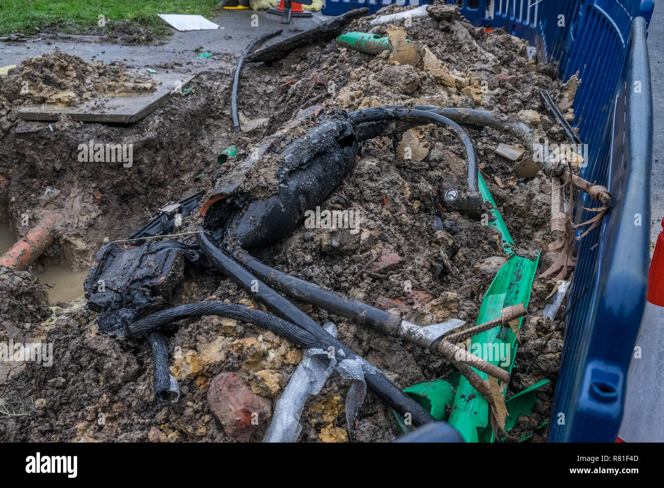 Main power cable repair in trench during heavy rain Stock Photo - Alamy