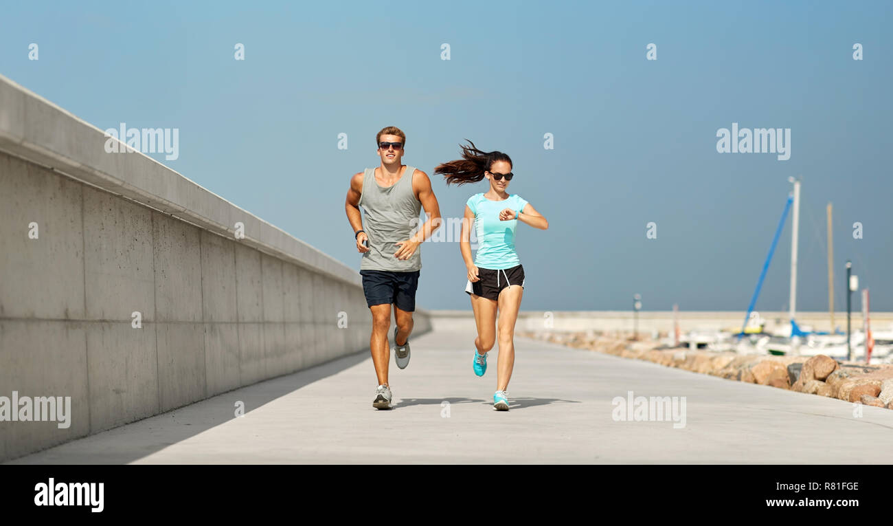 couple in sports clothes running outdoors Stock Photo - Alamy