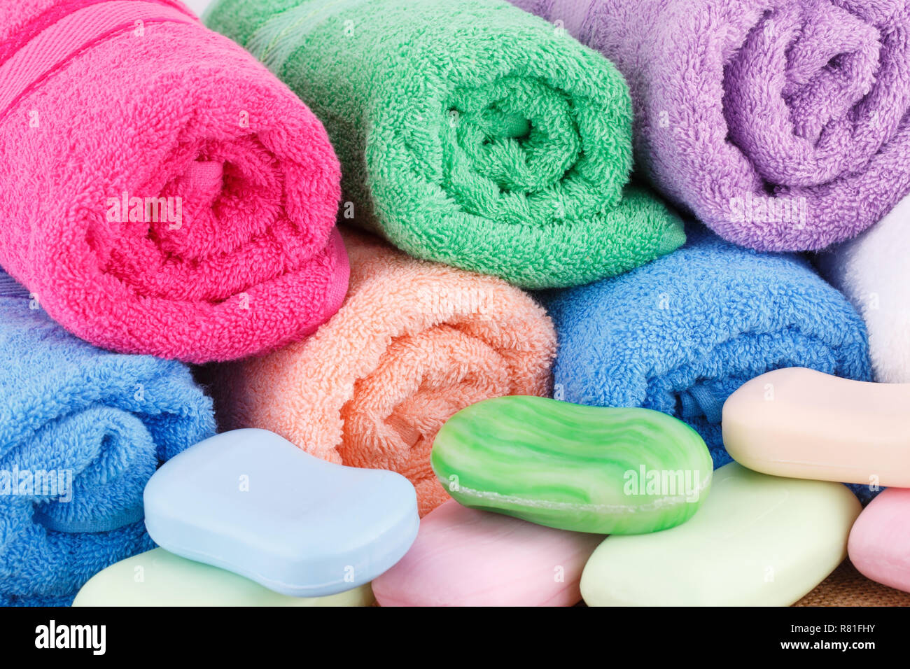 Colorful rolled towels with soaps closeup picture Stock Photo - Alamy