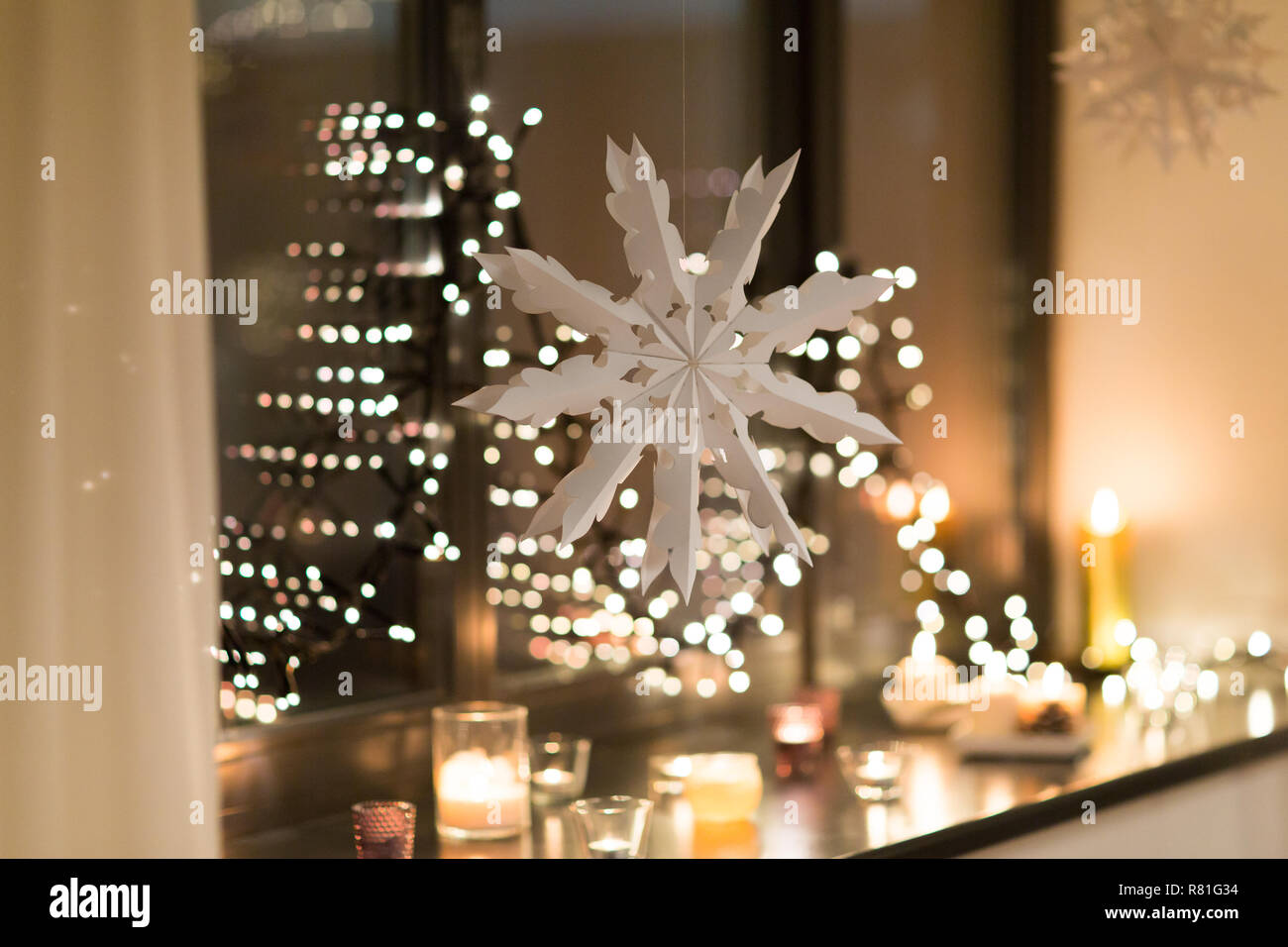 paper snowflake decoration hanging on window Stock Photo - Alamy