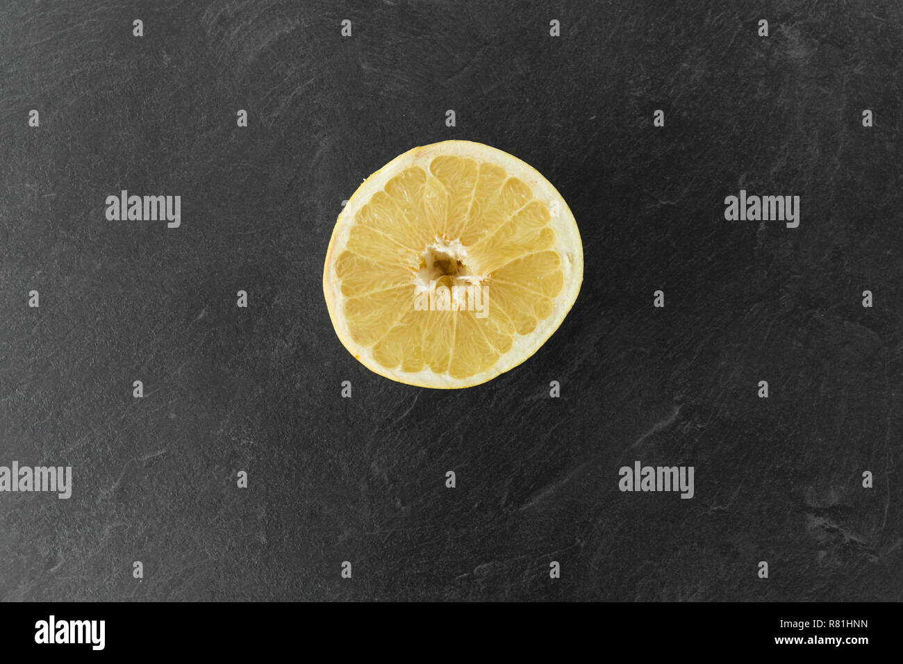 close up of lemon slice on slate table top Stock Photo - Alamy
