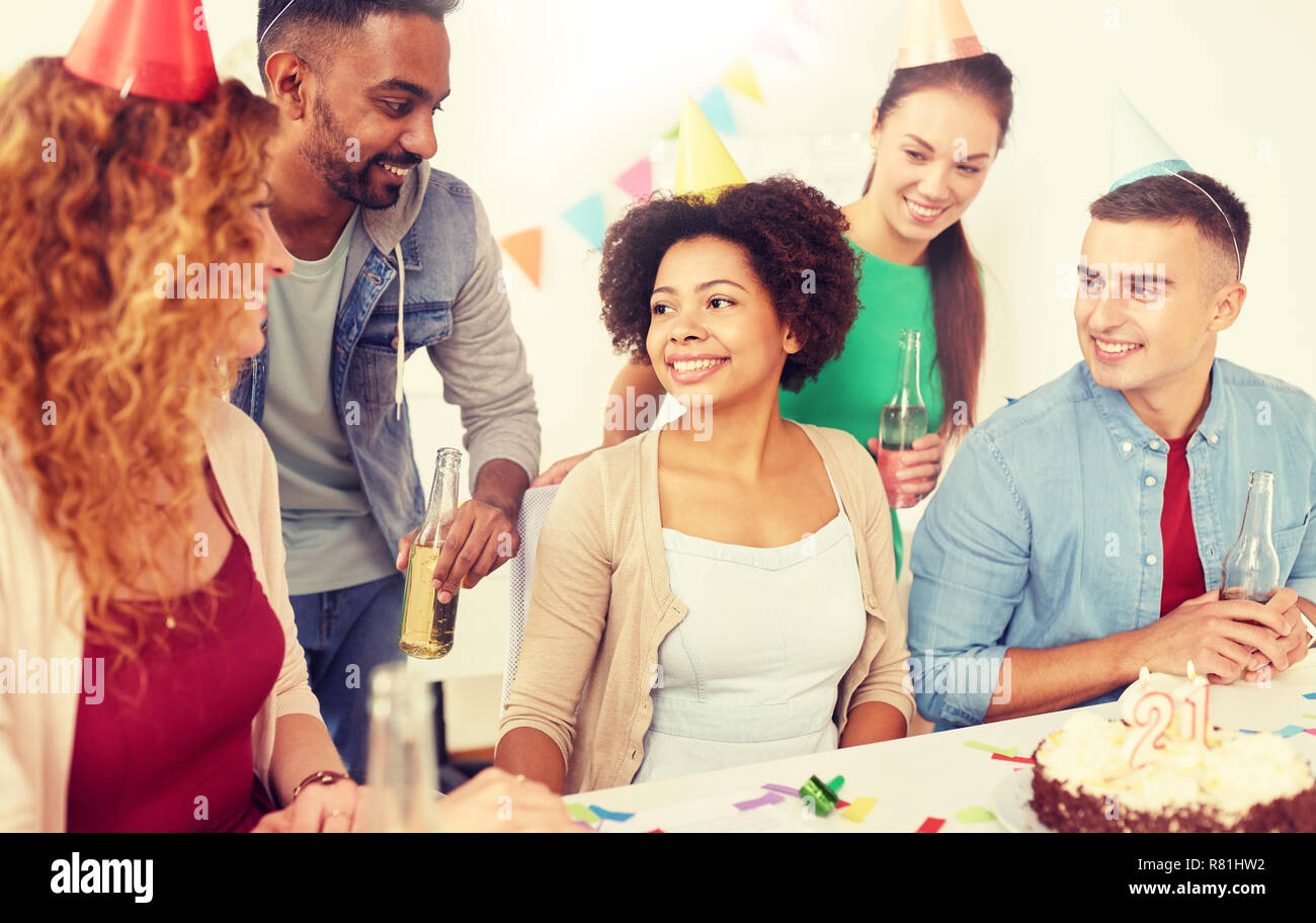 team greeting colleague at office birthday party Stock Photo - Alamy