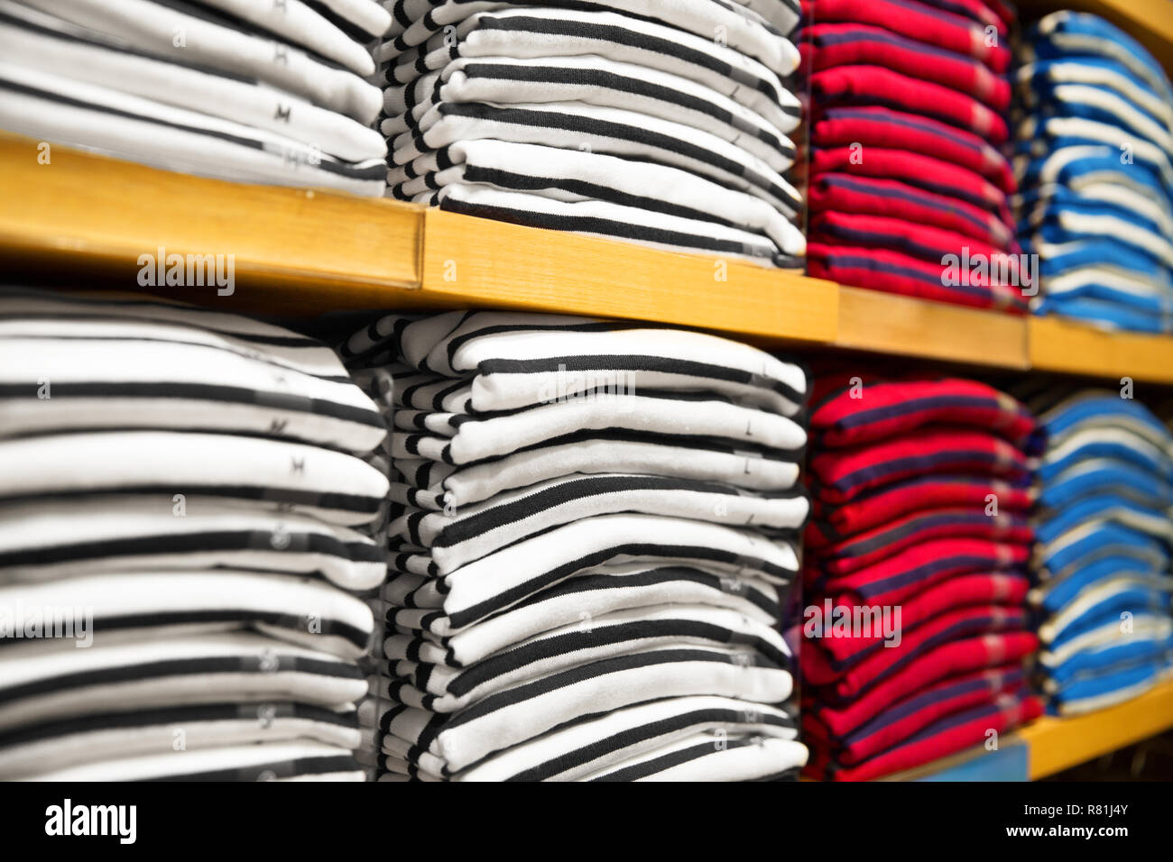 close up of shelves with clothes at clothing store Stock Photo - Alamy