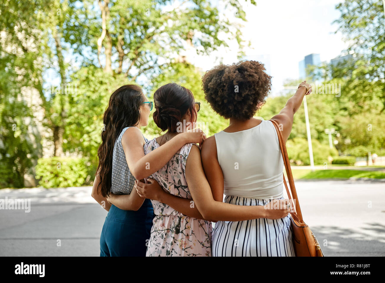 Back view three women hugging hi-res stock photography and images - Alamy