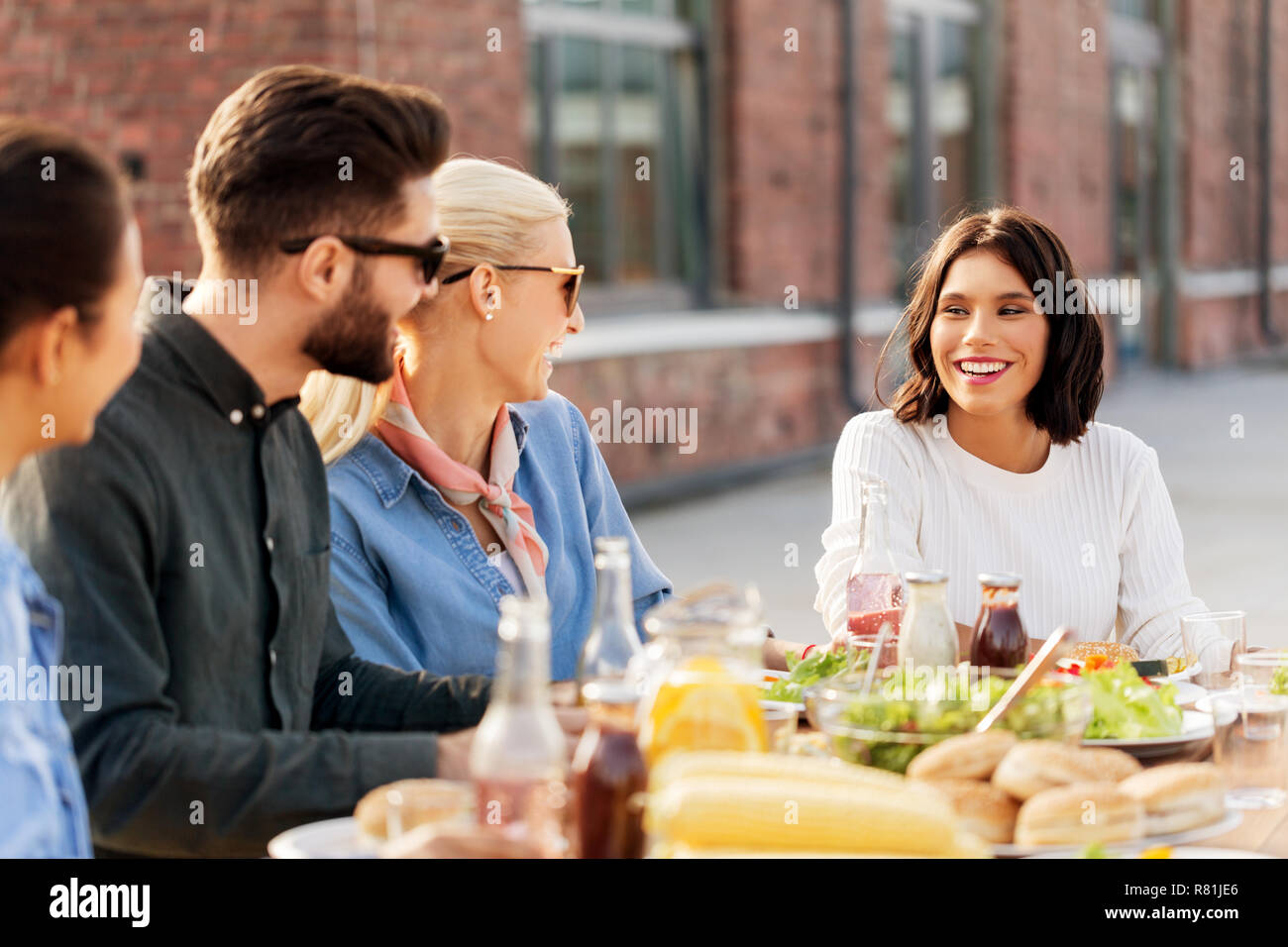 friends having dinner or bbq party on rooftop Stock Photo - Alamy