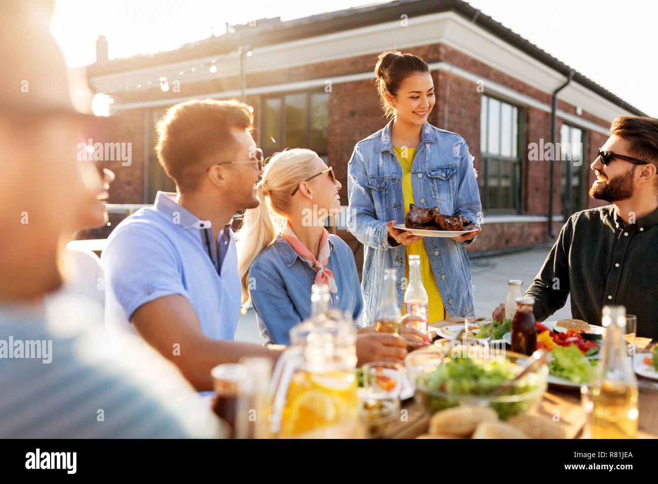 friends at barbecue party on rooftop in summer Stock Photo - Alamy
