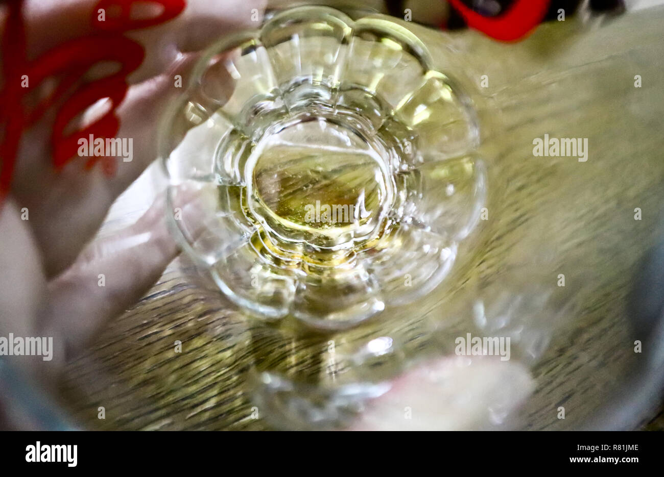 abstract image of hand hold glass of beer, top view of glass bottom ...