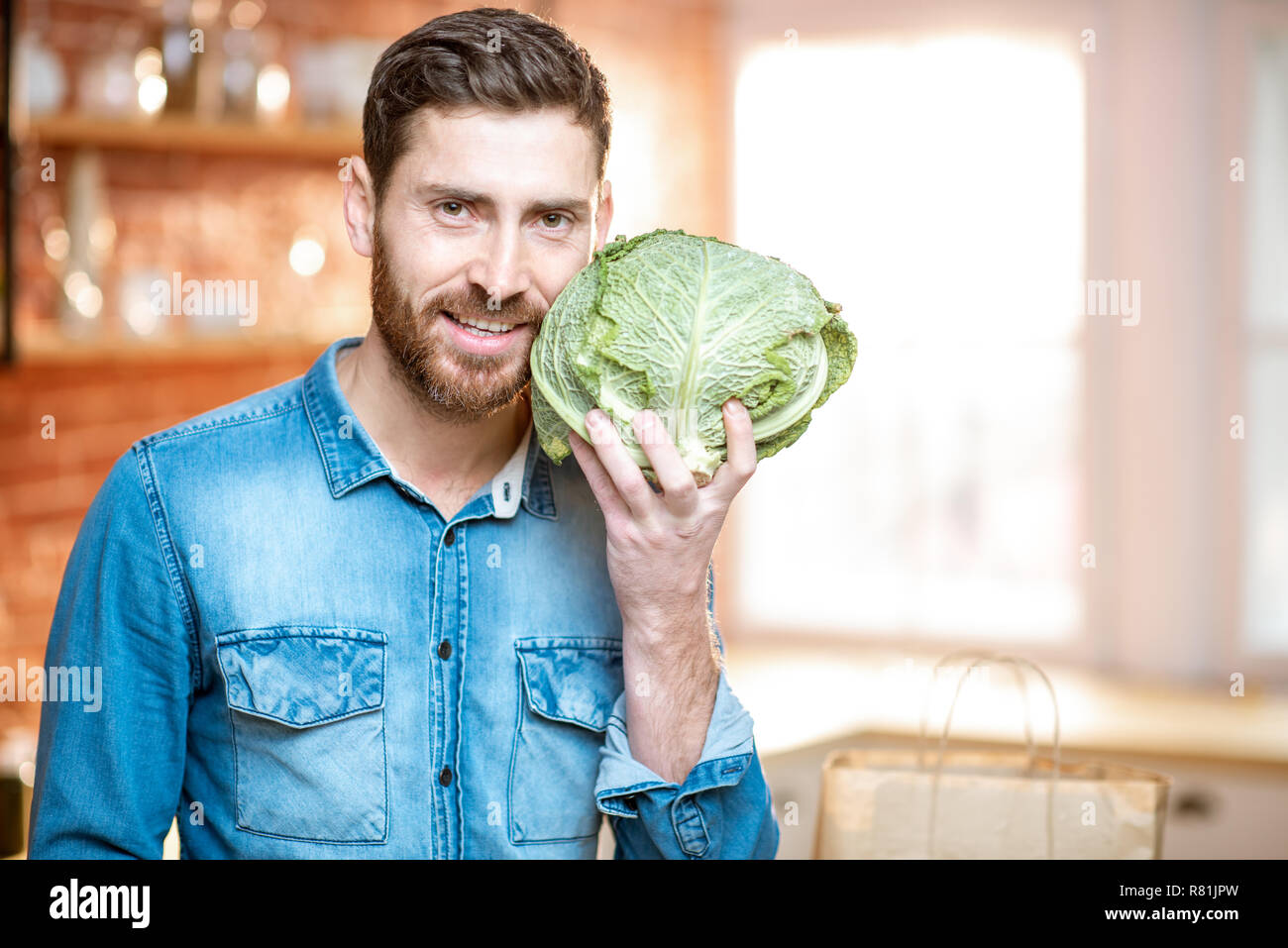 Man holding cabbage hi-res stock photography and images - Alamy