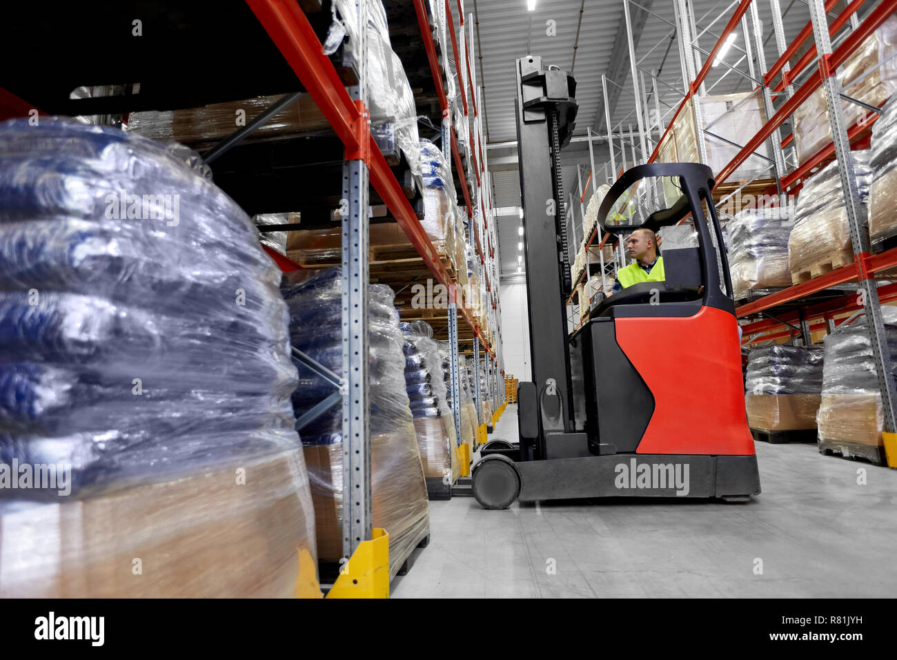 male loader operating forklift at warehouse Stock Photo - Alamy