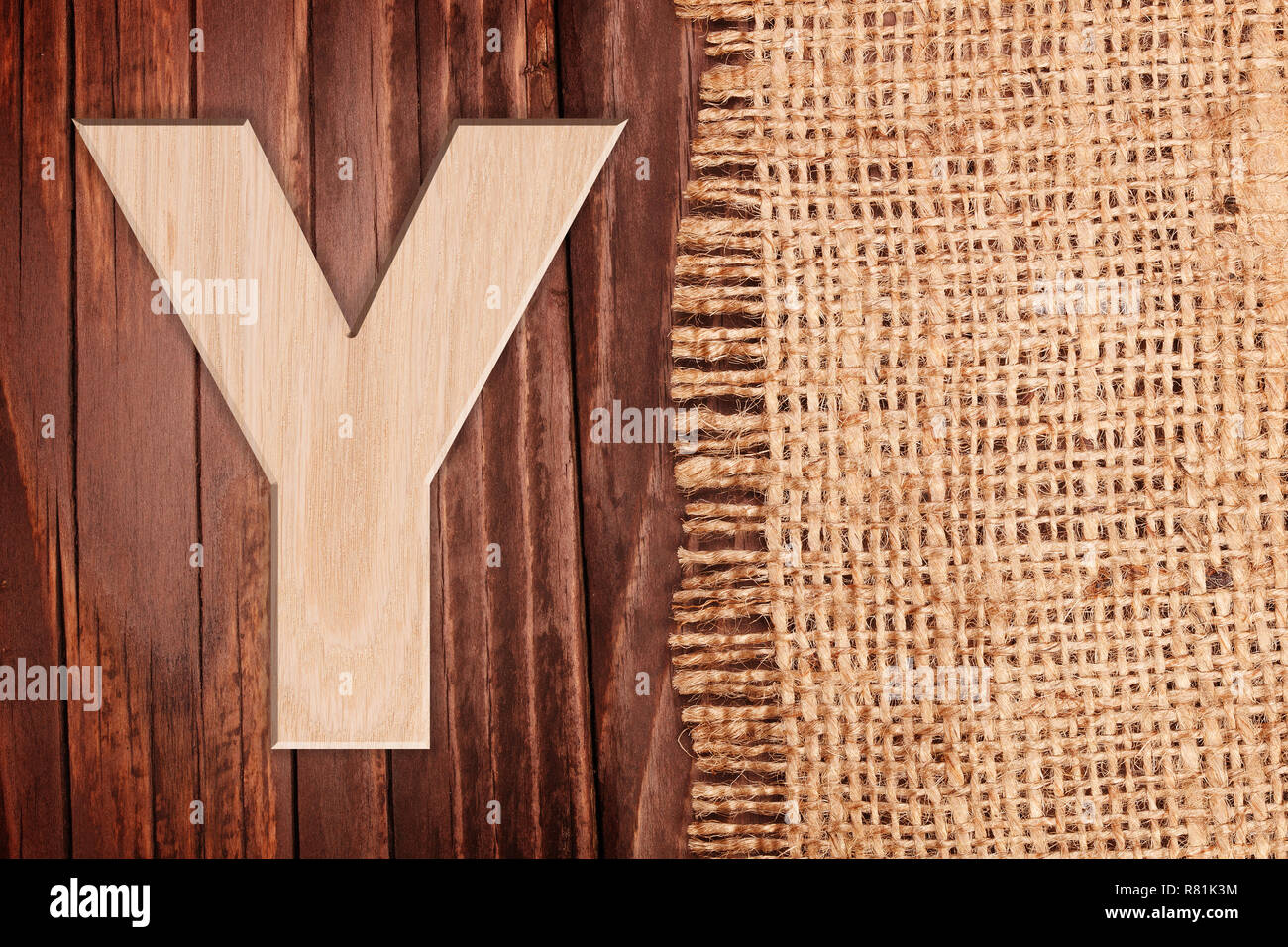 Wooden alphabet letter symbol - Y. On wooden table background wih ...