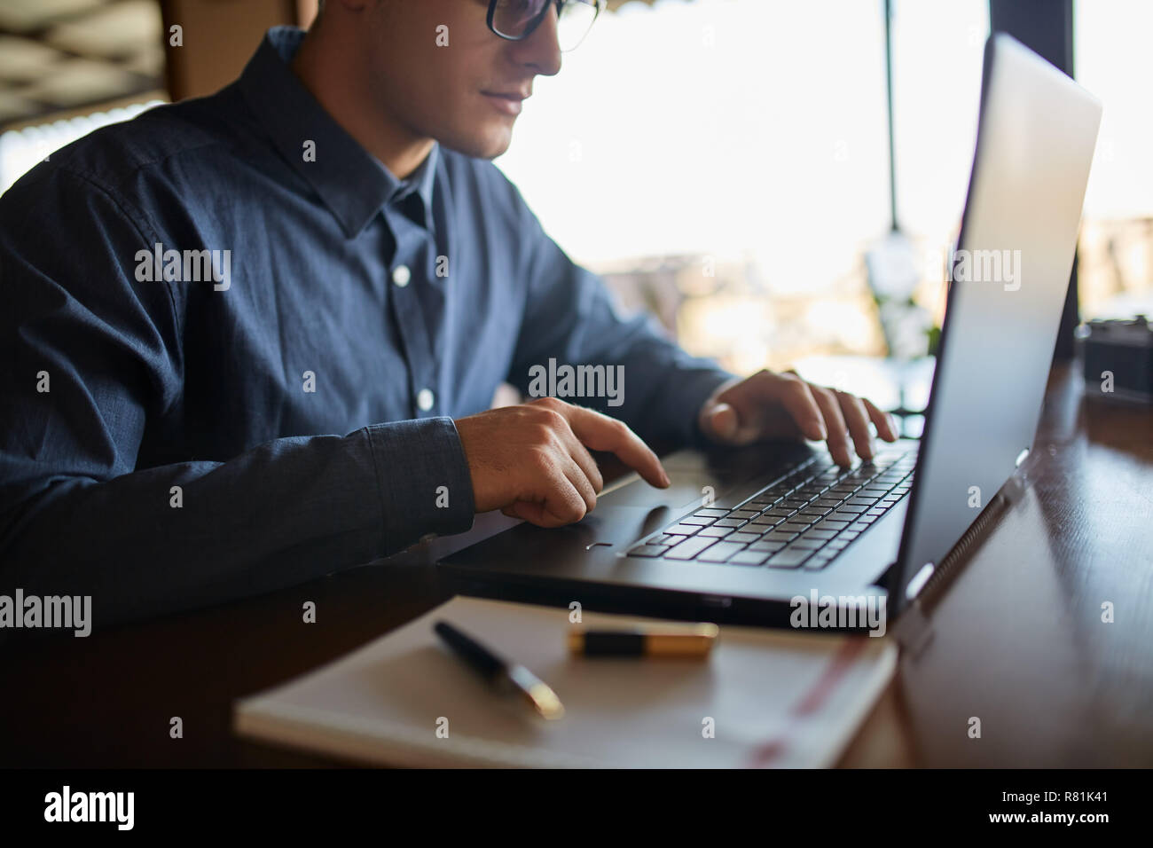 Close-up photo of caucasian male hands typing on laptop keyboard and ...