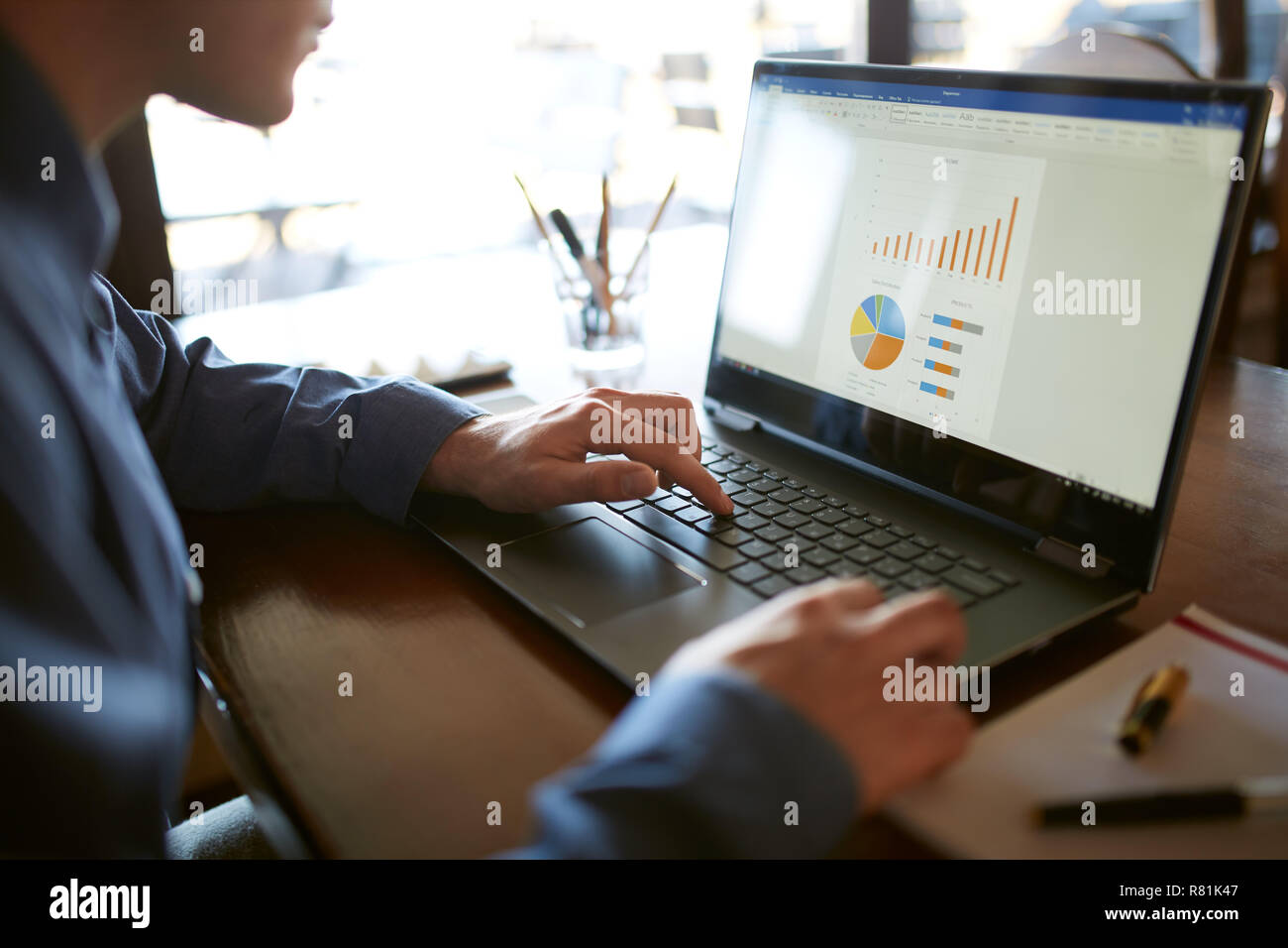 Close-up back view of caucasian businessman hands typing on laptop ...