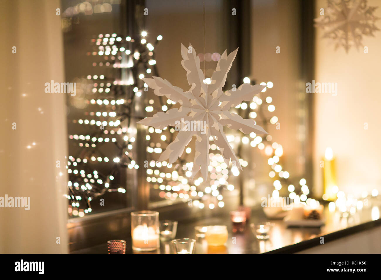 paper snowflake decoration hanging on window Stock Photo - Alamy