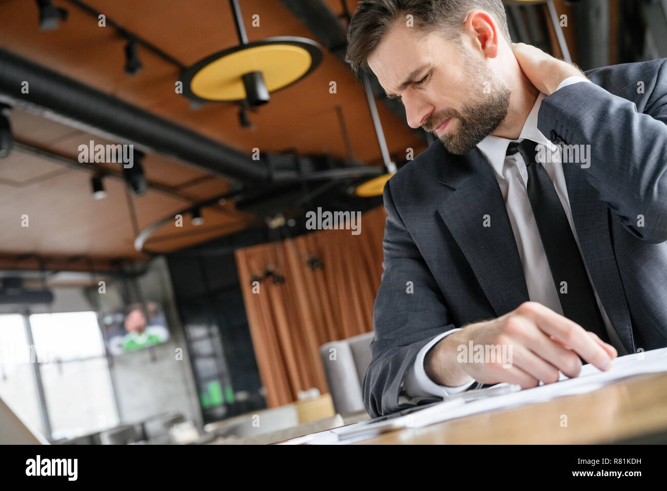 Businessperson on business lunch at restaurant sitting touching neck ...