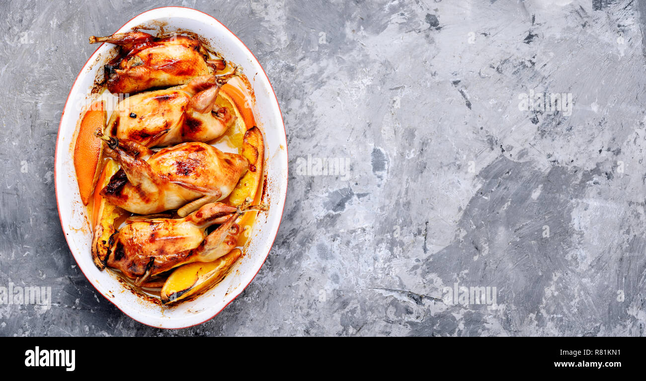 Carcasses of quail roasted with orange sauce Stock Photo - Alamy