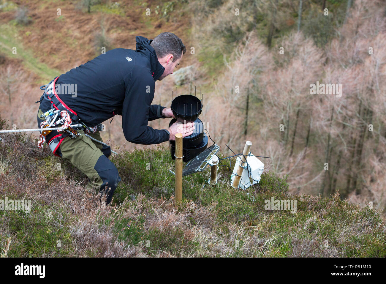 A scientist removes the automatic crack measuring equipment, that ...